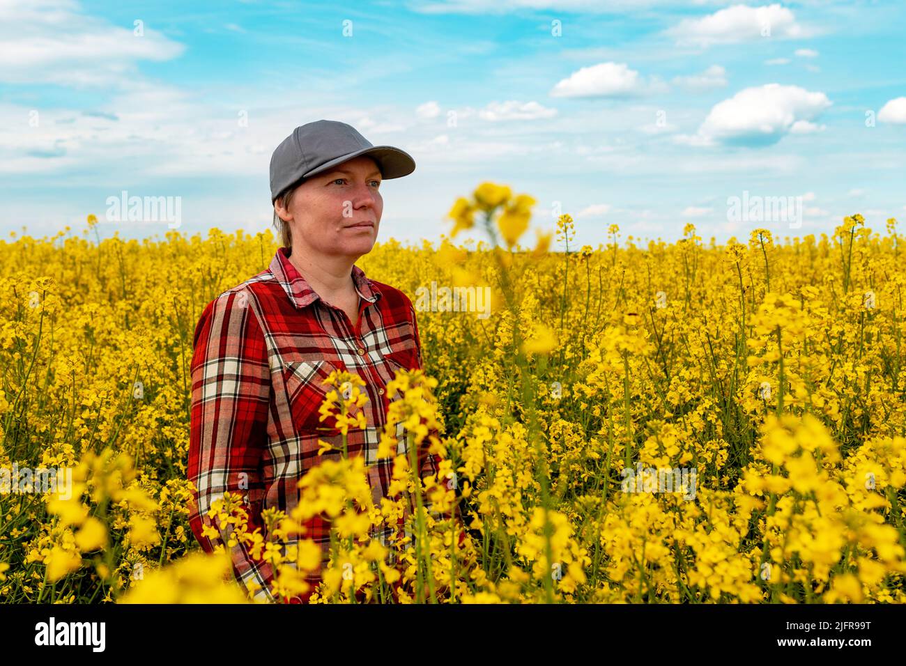 Confident and self-assured farm worker wearing red plaid shirt and ...