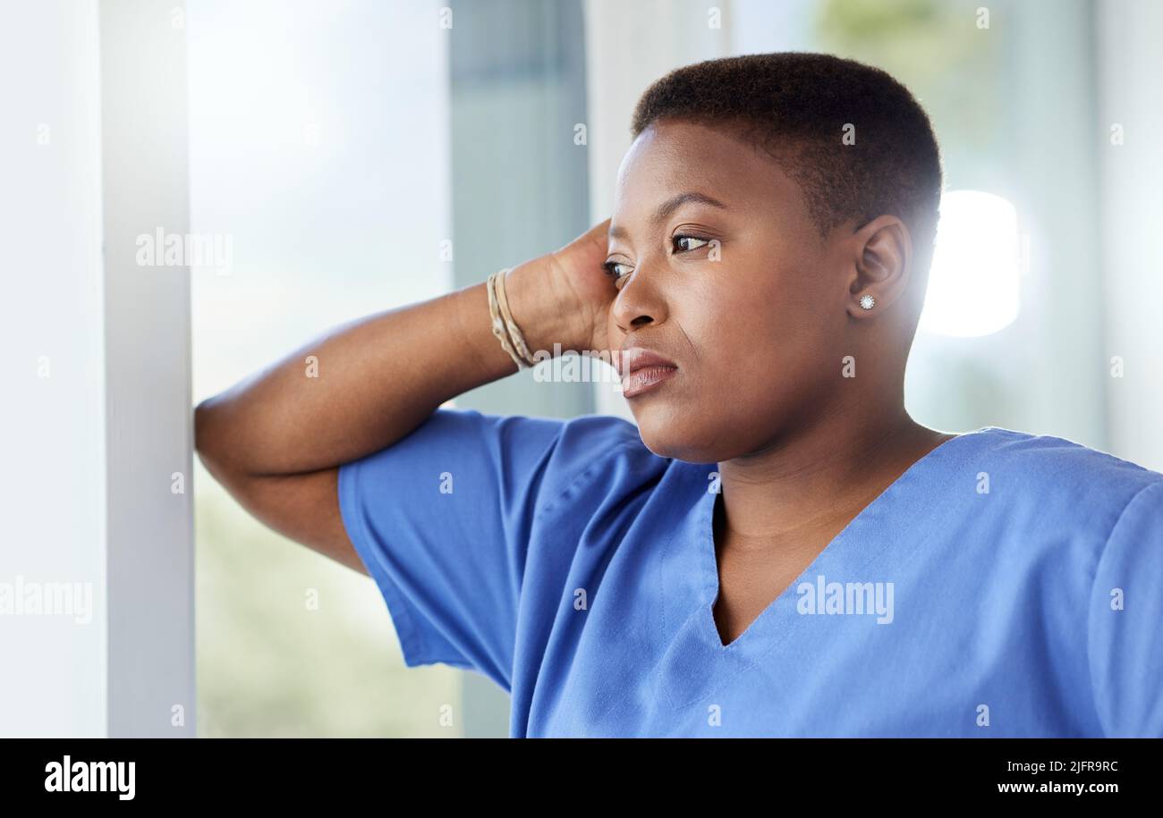 Every nurse was drawn to nursing. Shot of a female nurse looking ...