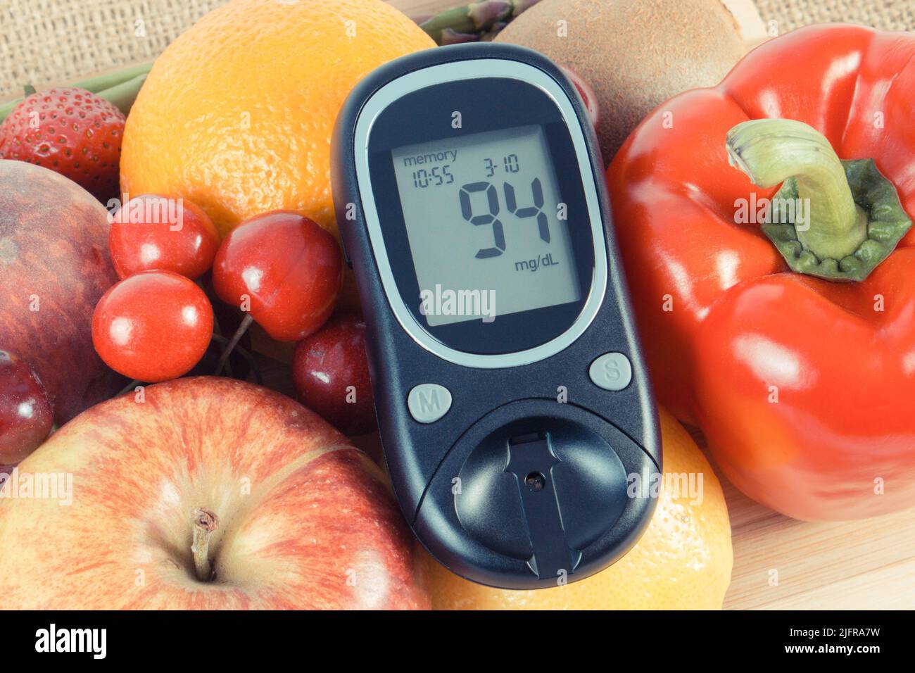 Glucometer with result of measurement sugar level and fresh ripe ...