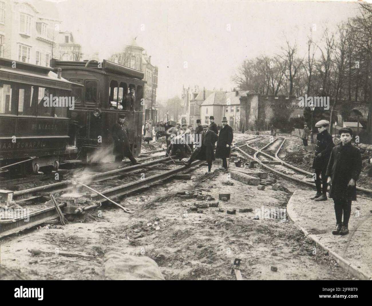 Construction of tram rails on the left a steam tram Stock Photo - Alamy
