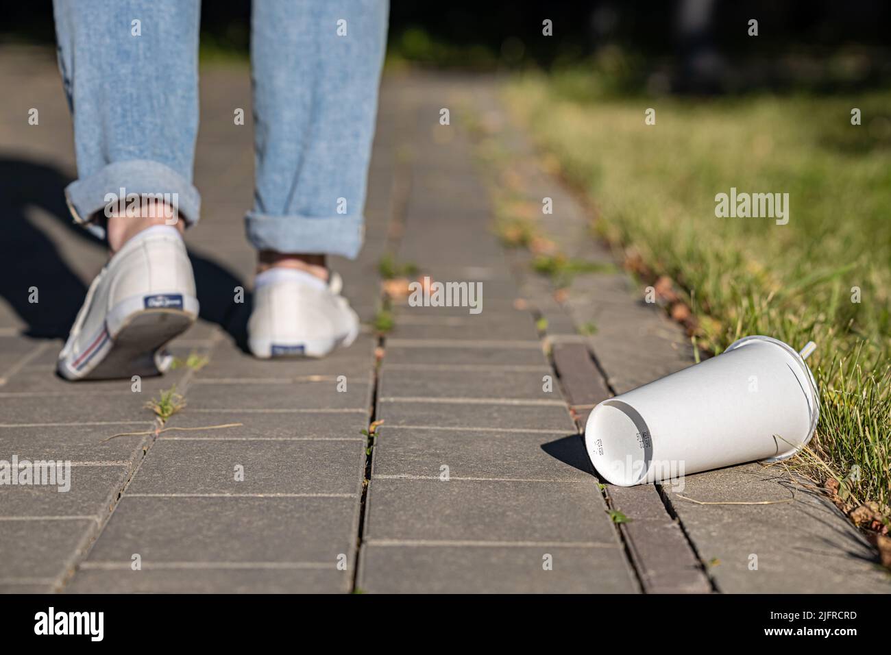 paper disposable cup thrown on the sidewalk Stock Photo - Alamy