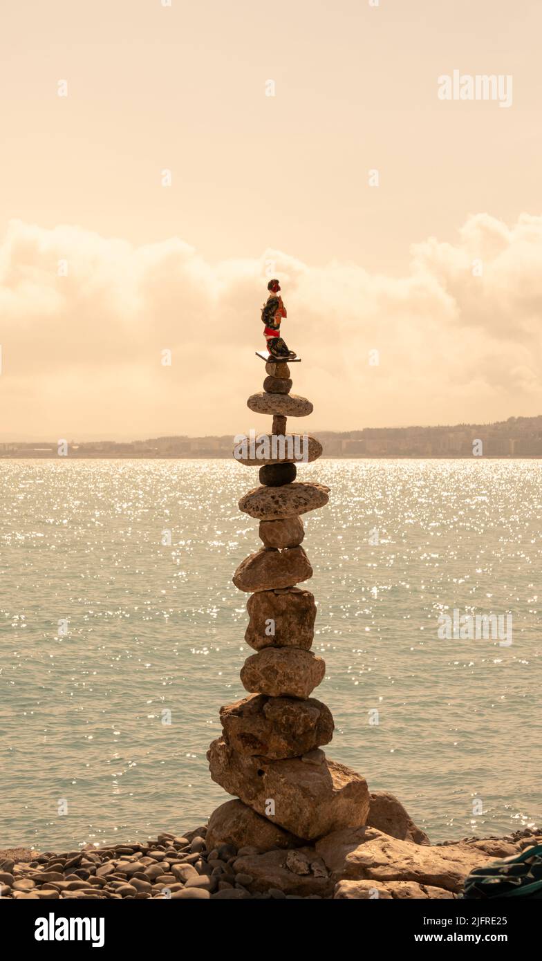 The art of stone balancing in the beautiful light of the sunset on the ...