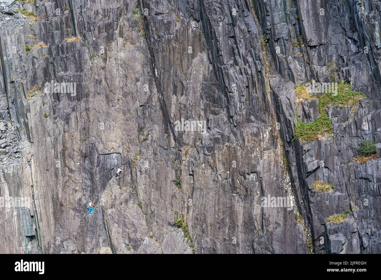 Dinorwic slate quarry showing climbers on cliff face formed from slate ...