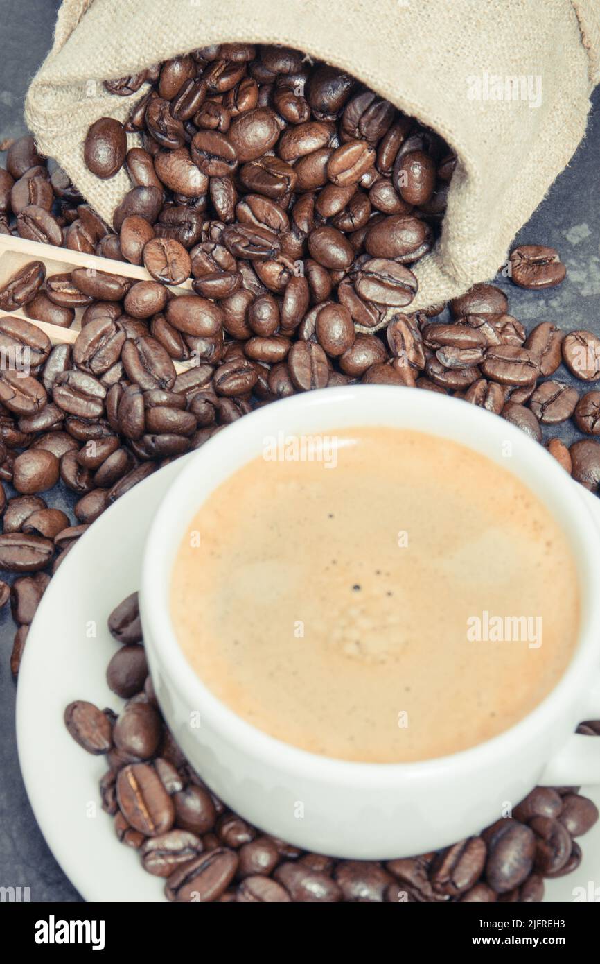 White glass cup of coffee and roasted dark fragrant coffee grains Stock ...