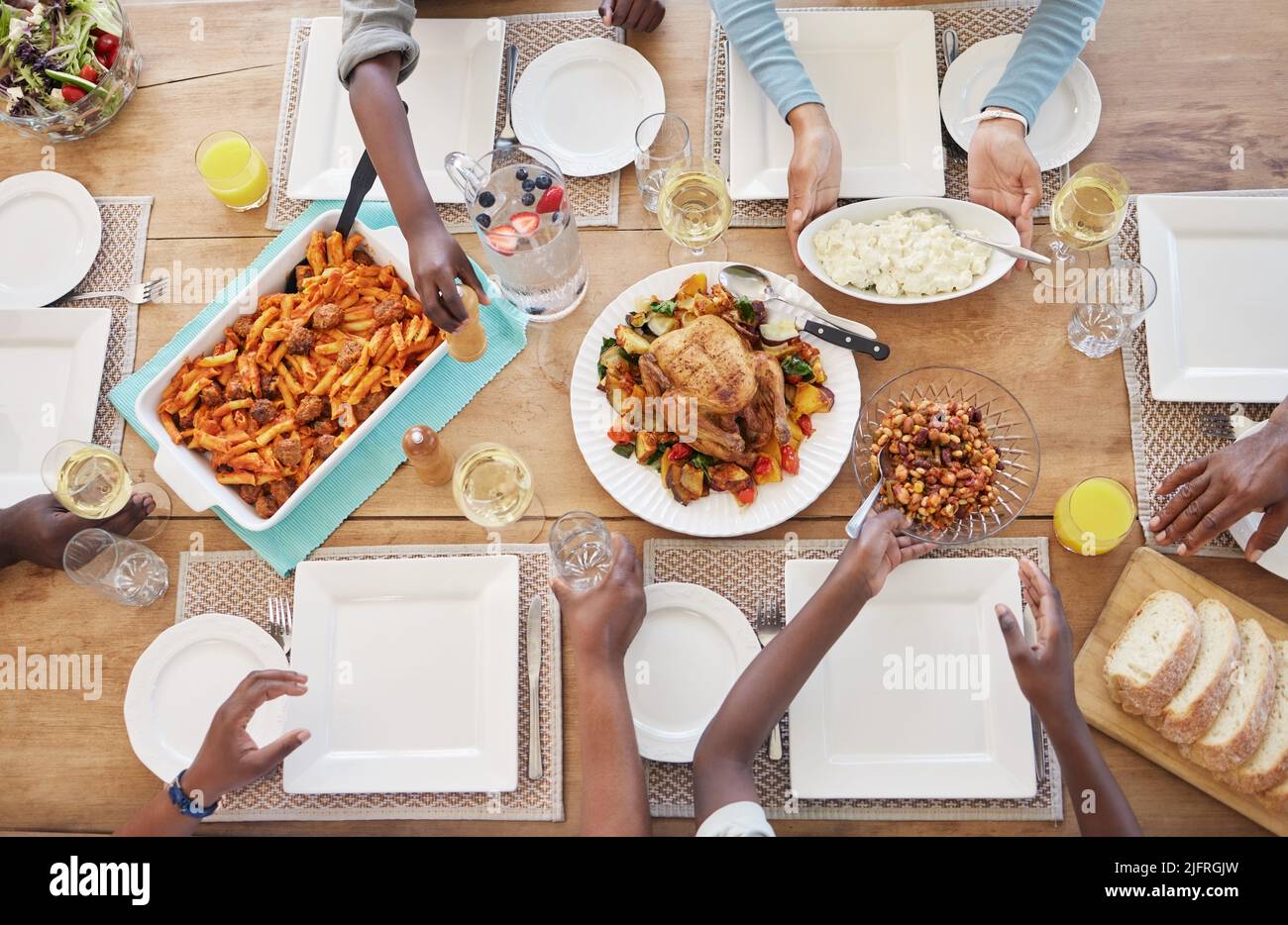 Food tastes better when you eat it with your family. Shot of lunch on a ...