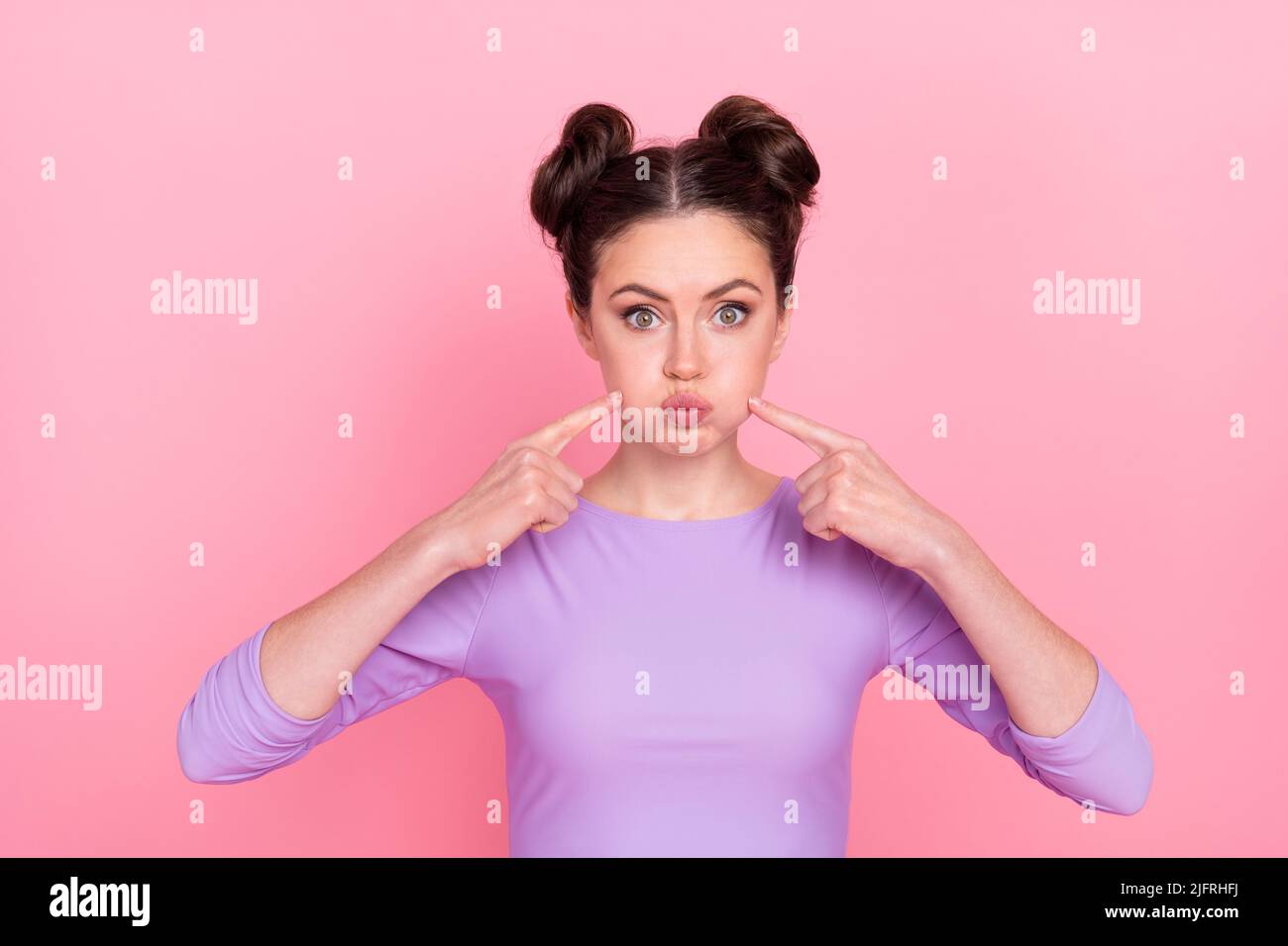 Portrait Of Attractive Funny Cheery Girl Blowing Touching Cheeks