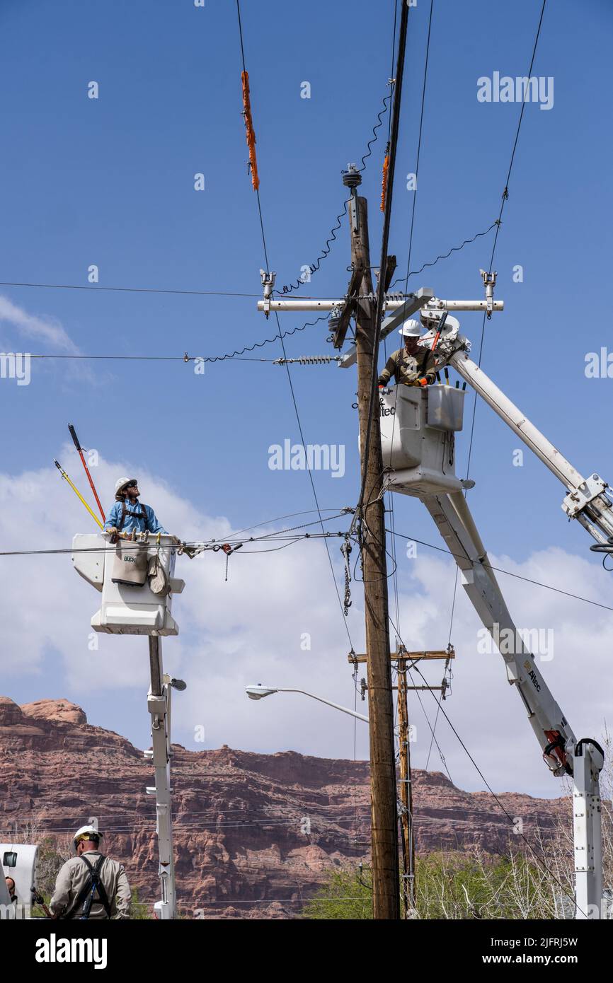 Electrical workers make perform maintenance on live electrical ...