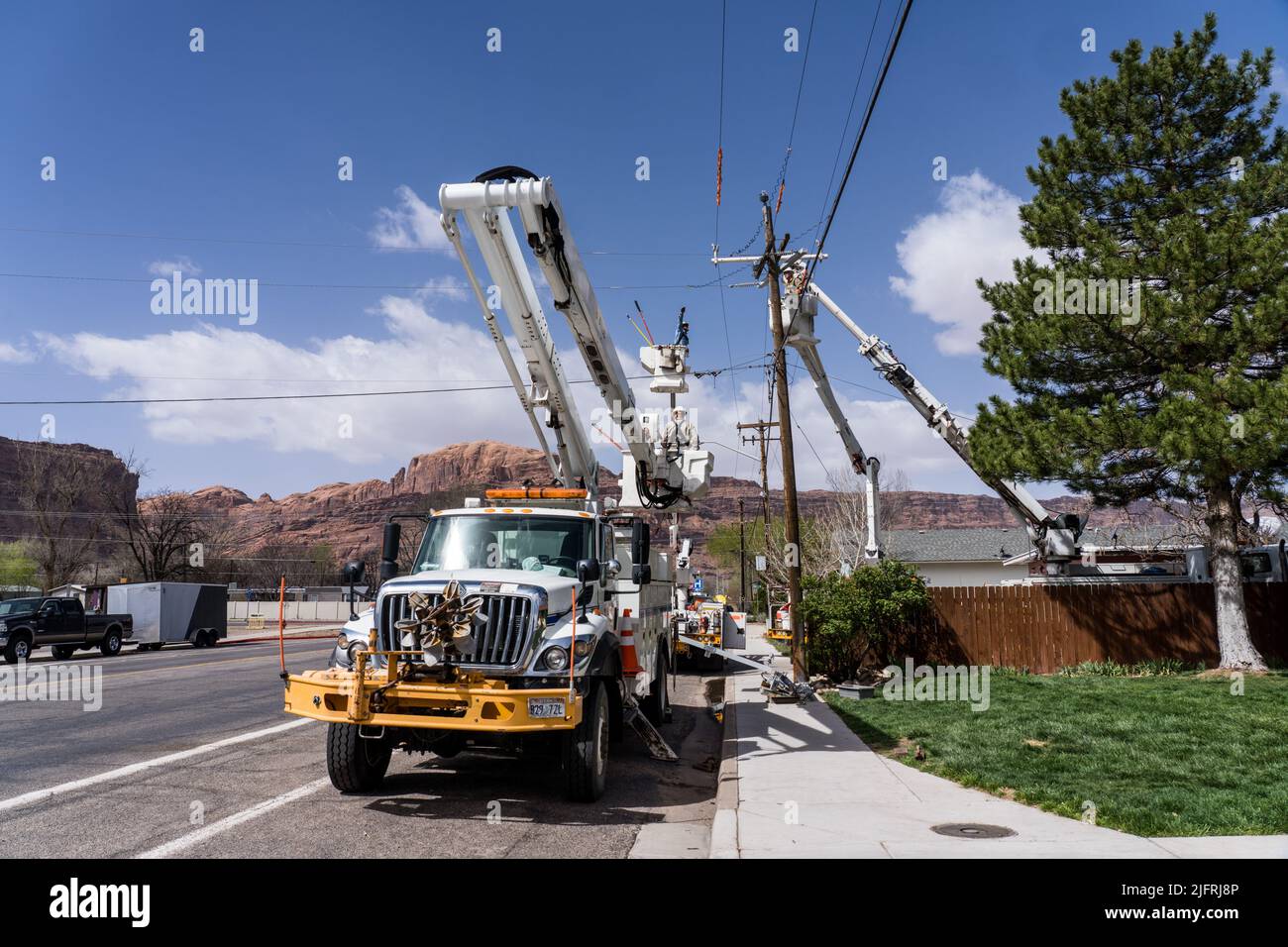 Electrical workers make perform maintenance on live electrical ...