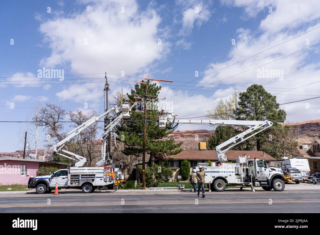 Electrical workers make perform maintenance on live electrical ...