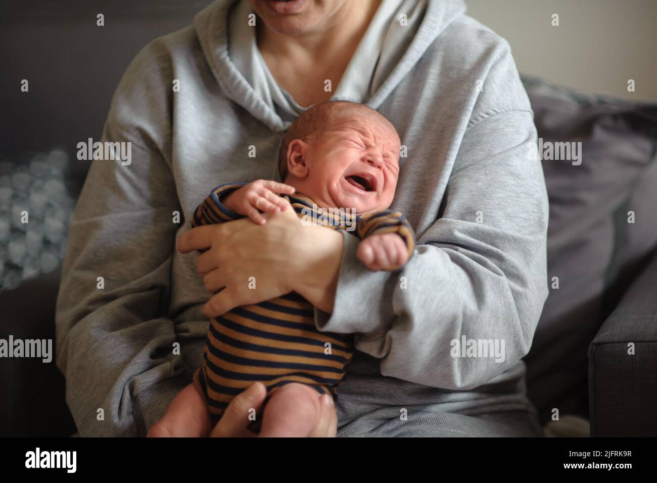 Sweet and cute small little newborn baby is hungry and upset and cry ...