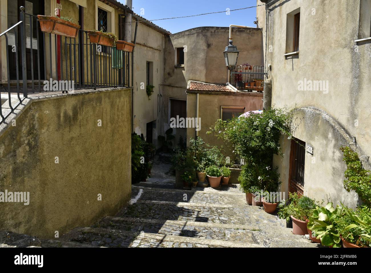A narrow street among the old houses of Altomonte village, Calabria ...