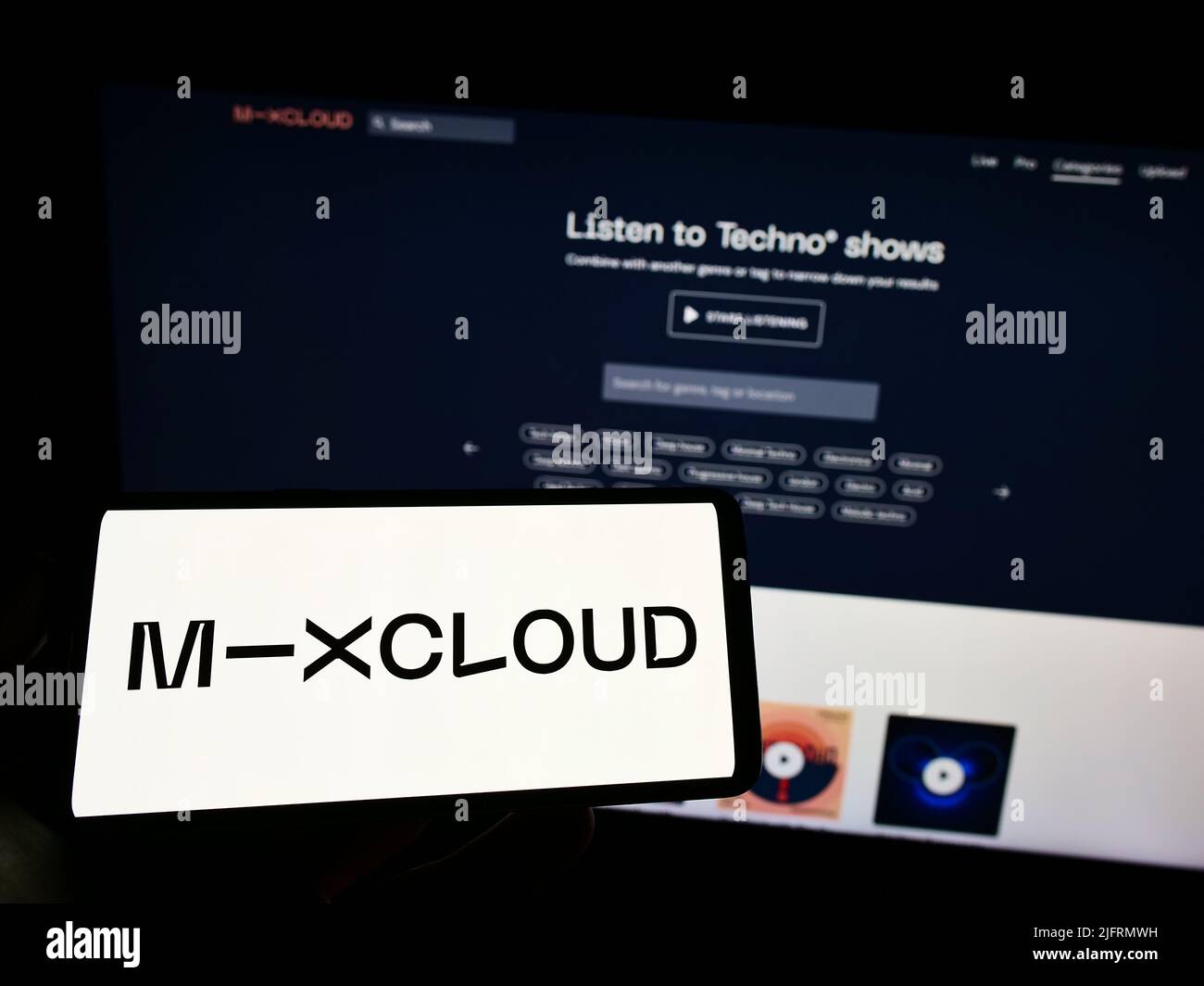 Person holding smartphone with logo of British music streaming company ...