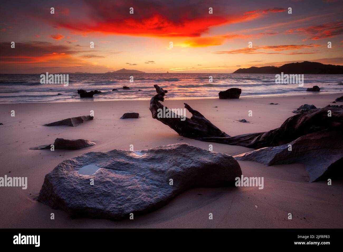 Ding Bay sunrise, Northland, New Zealand. Hen Island in the distance ...