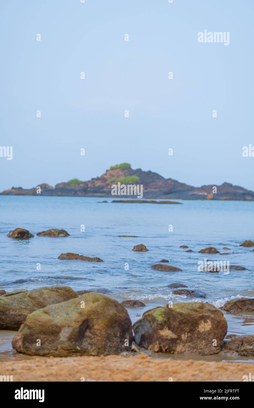 Clear view of random rocks in seashore at om beach Stock Photo - Alamy
