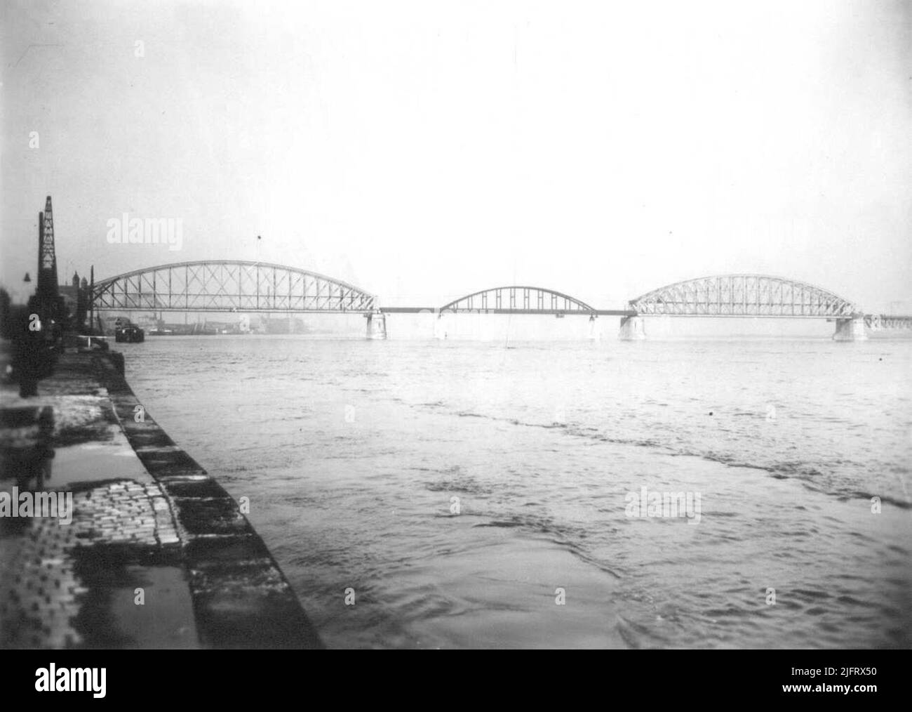 The railway bridge with the middle segment destroyed by its own troops ...