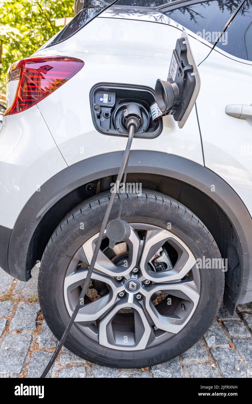 electric car being charged (detail) cable plug and socket of an ...