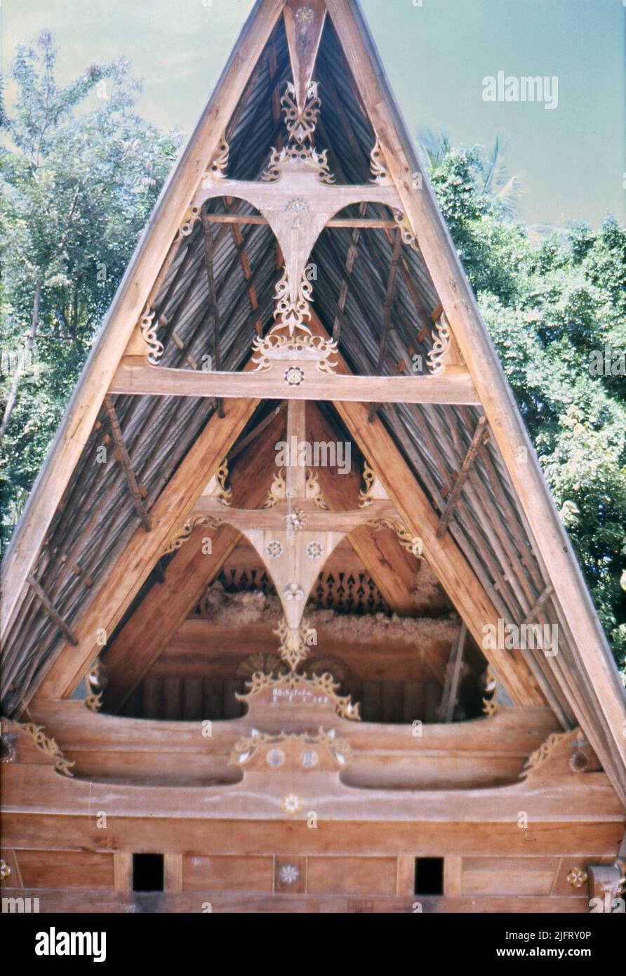 Sumatra, circa.1970. An intricately carved gable roof of a Batak house ...