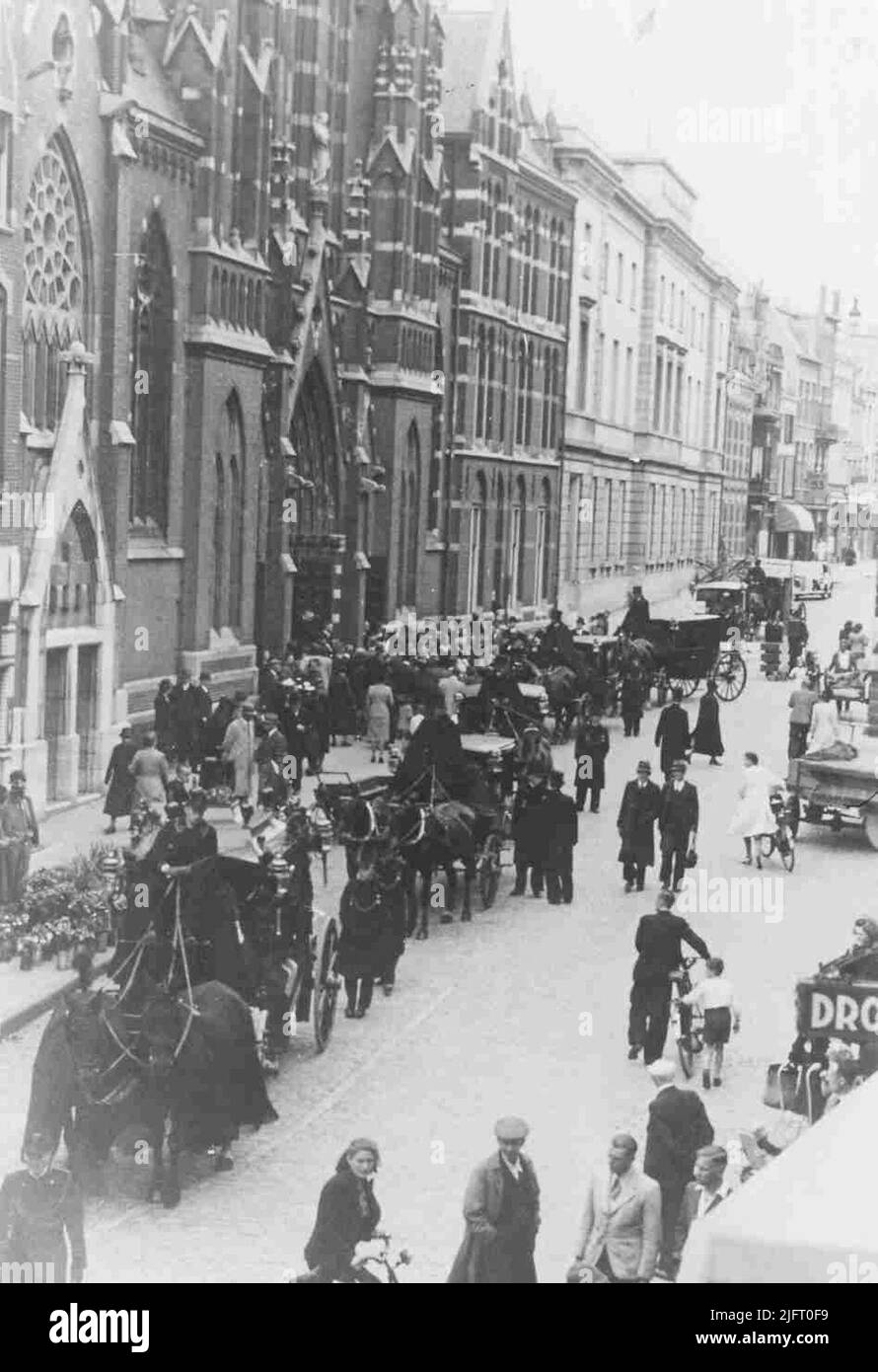 Funeral (van Meurs). Swastikas flag fluttering on the roof of the old ...