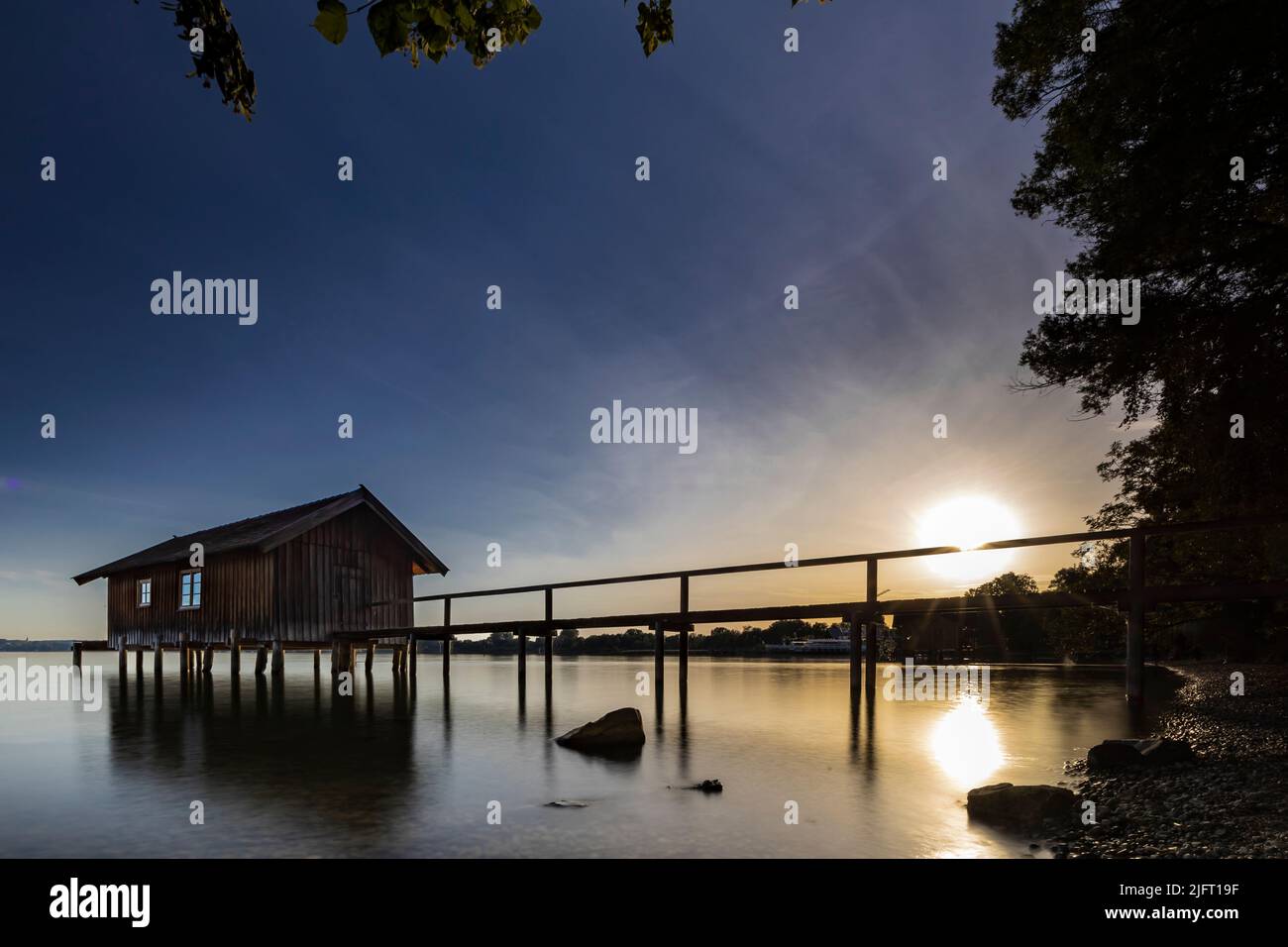 A breathtaking view of lake house against blue sunset sky Stock Photo ...