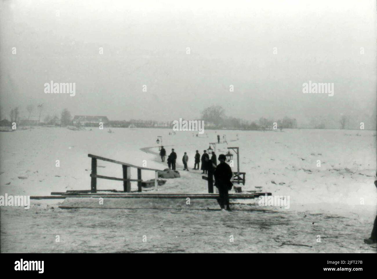 The frozen river De Waal with in the foreground the jetty of the ...