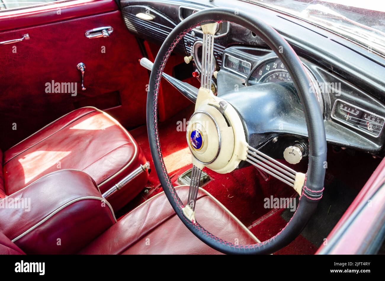Red interior of a vintage 1956 Sunbeam Talbot with steering wheel and ...