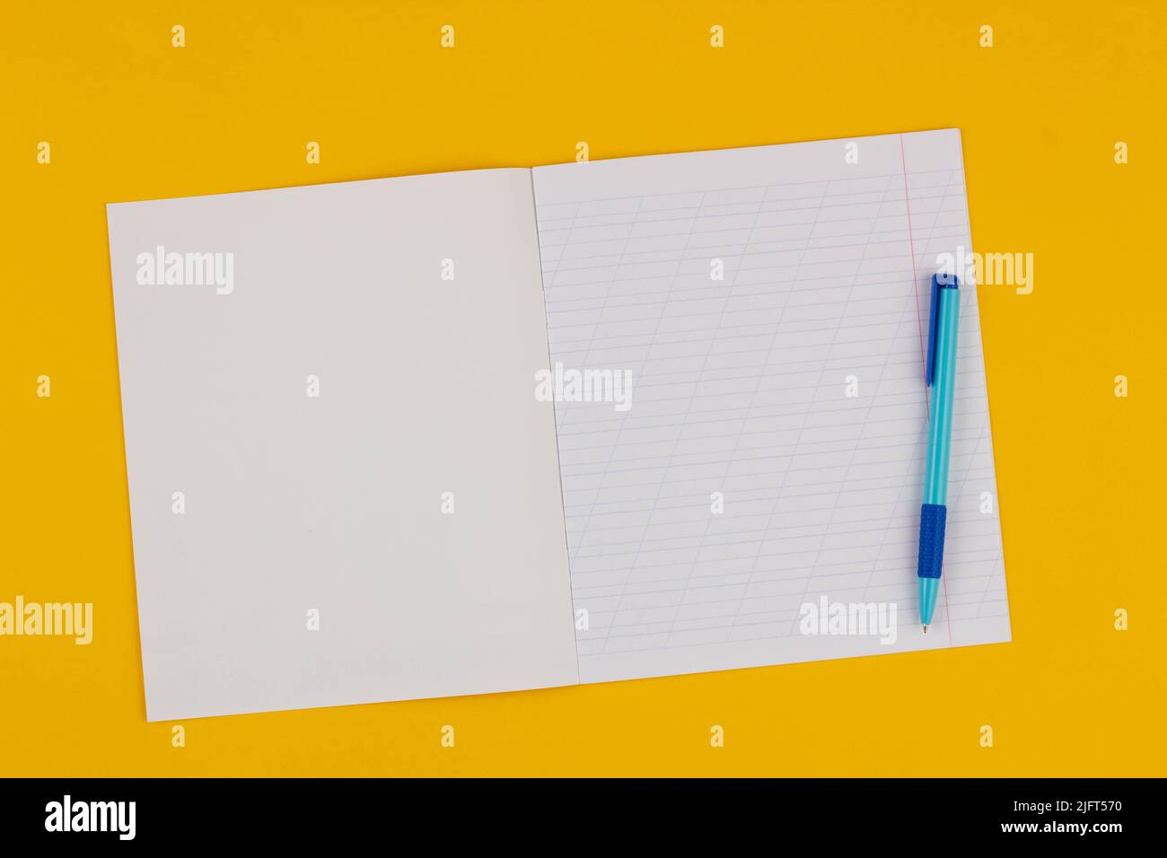 School notebook on a yellow background with copy space for text and ...