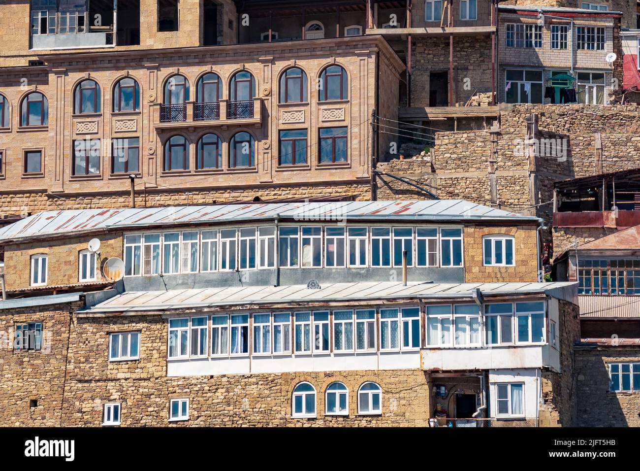 facades of houses located in tiers on a steep slope in the village of ...
