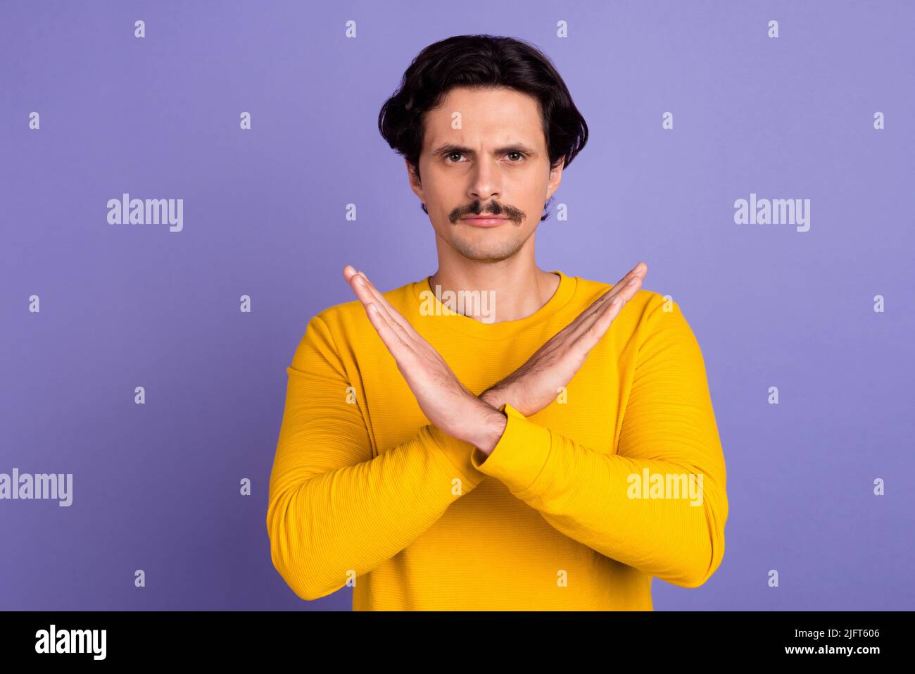 Photo of confident focused young man crossed arms demonstrate stop ...