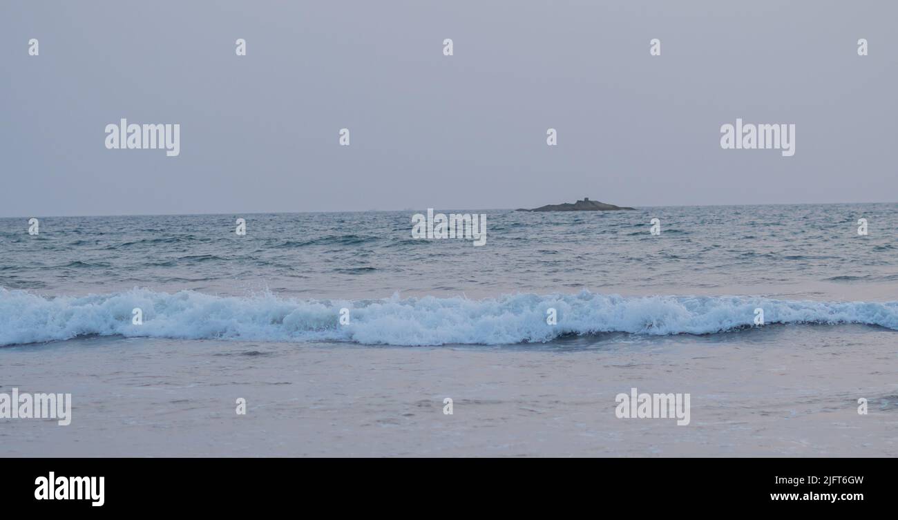 One big wave with white foam coming to the seashore.i land at the back ...