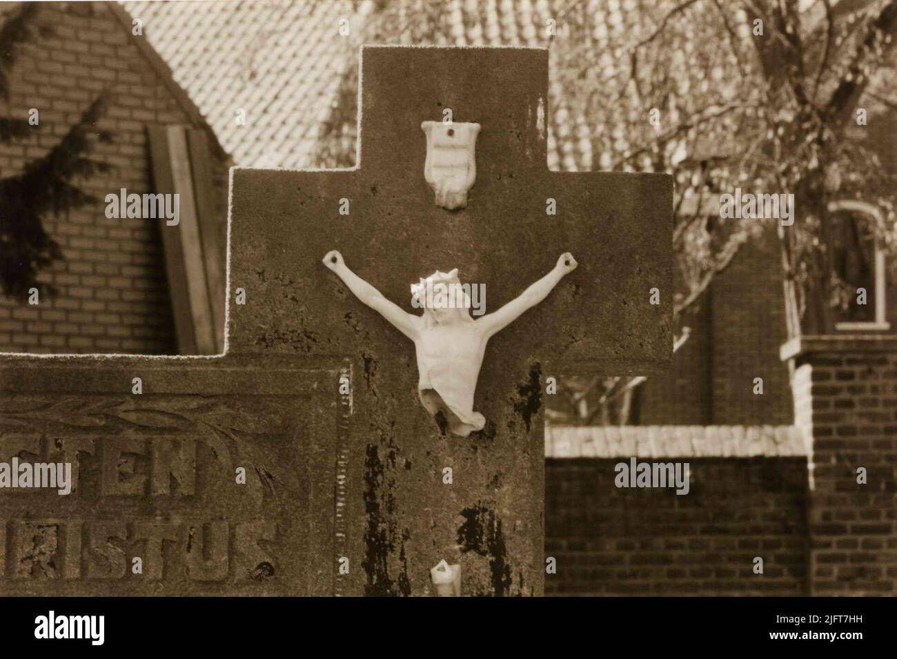 Cemetery. Crucifixed Jesus on the edge of the cemetery with a view of ...