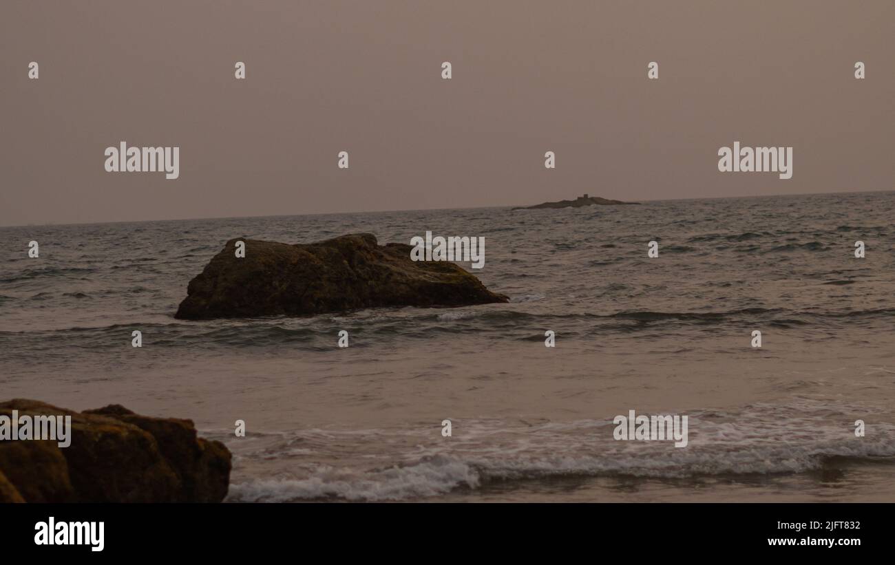 Three rocks in ocean.rocks aligned in perspective in ocean.rock i the ...