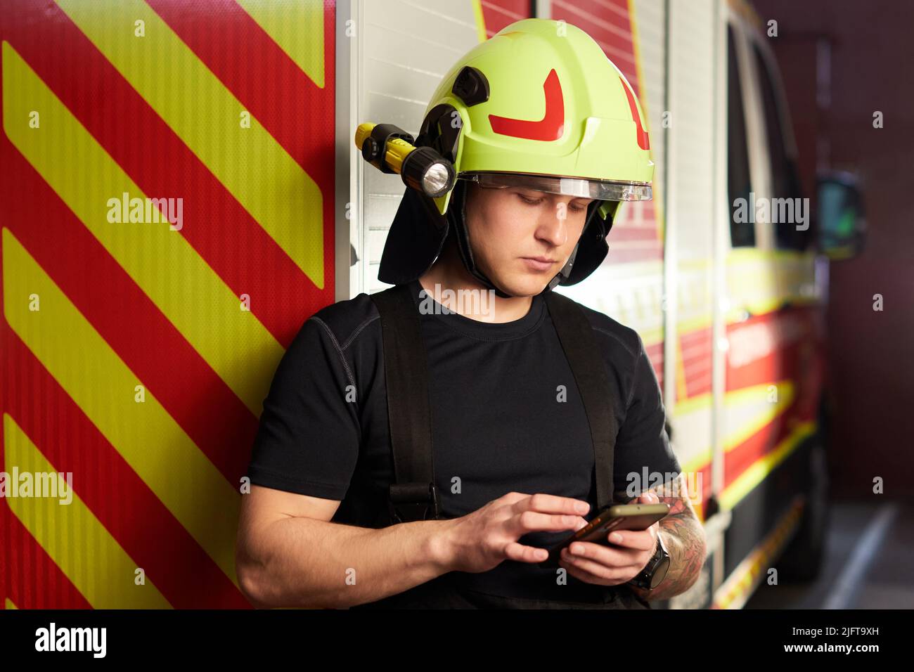 Portrait of a firefighter standing in front of a fire engine Stock ...