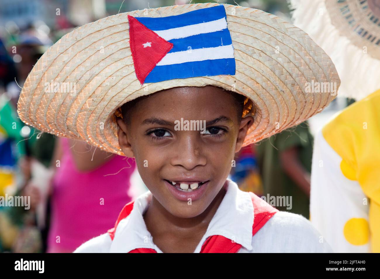 Cuba,Santiago de Cuba. Carnaval in July. Boy wearing straw hat with ...