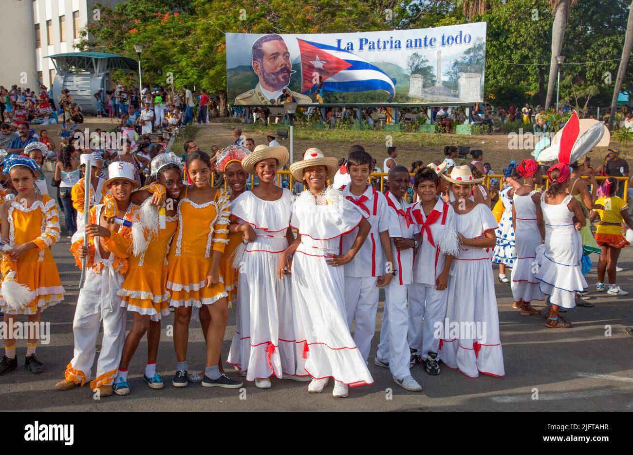 Cuba,Santiago de Cuba. Carnaval in july. Group in front of flag 'La ...