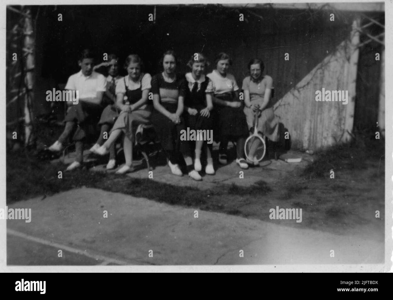 Members of the tennis club pose on the track behind Hotel Pension ...