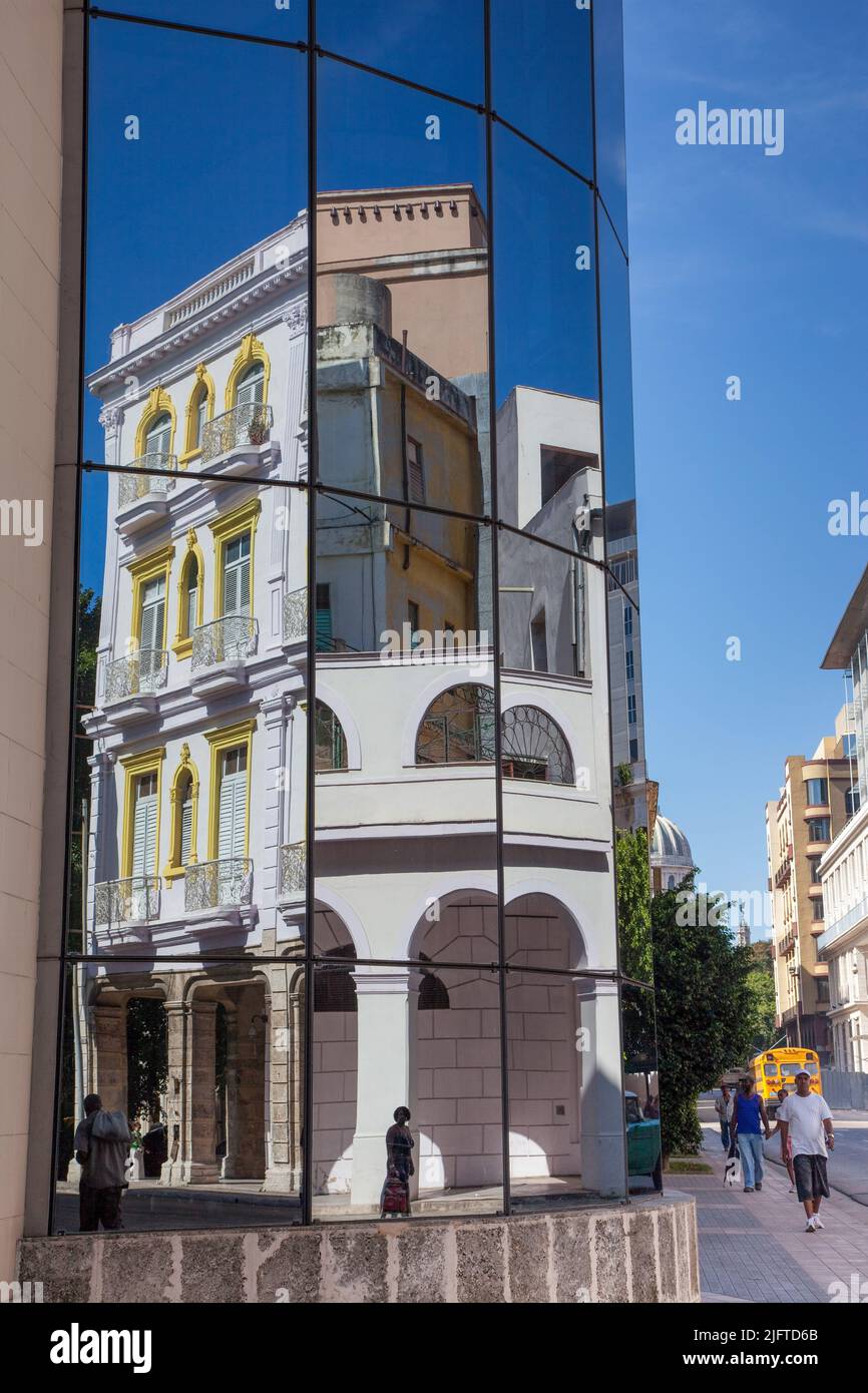 Cuba, Havana, A modern building with reflecting mirror facade is ...