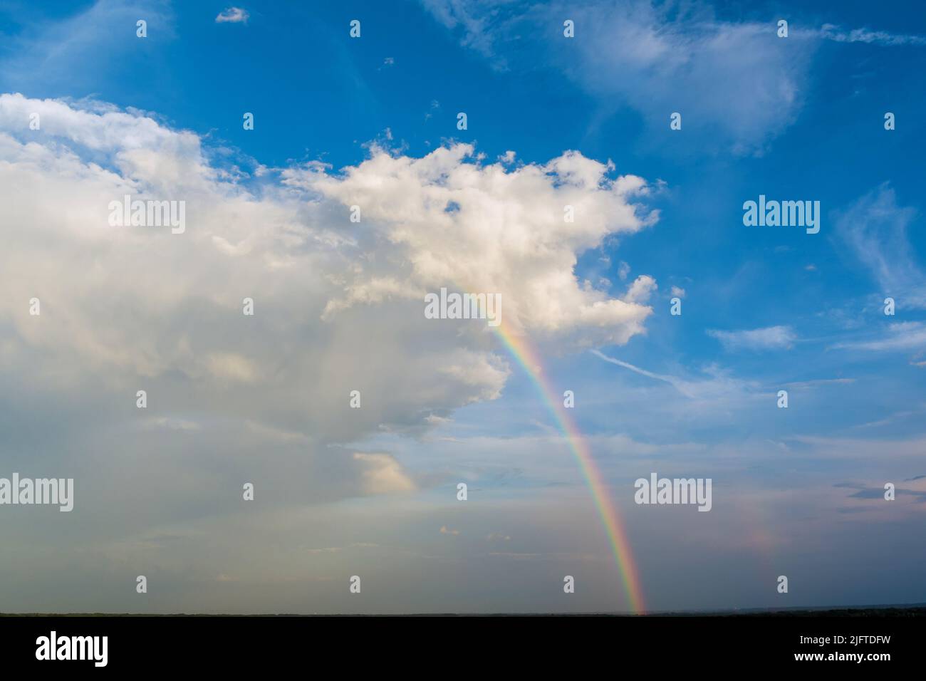 Magnificent panorama of a multicolored rainbow after rain with clouds ...
