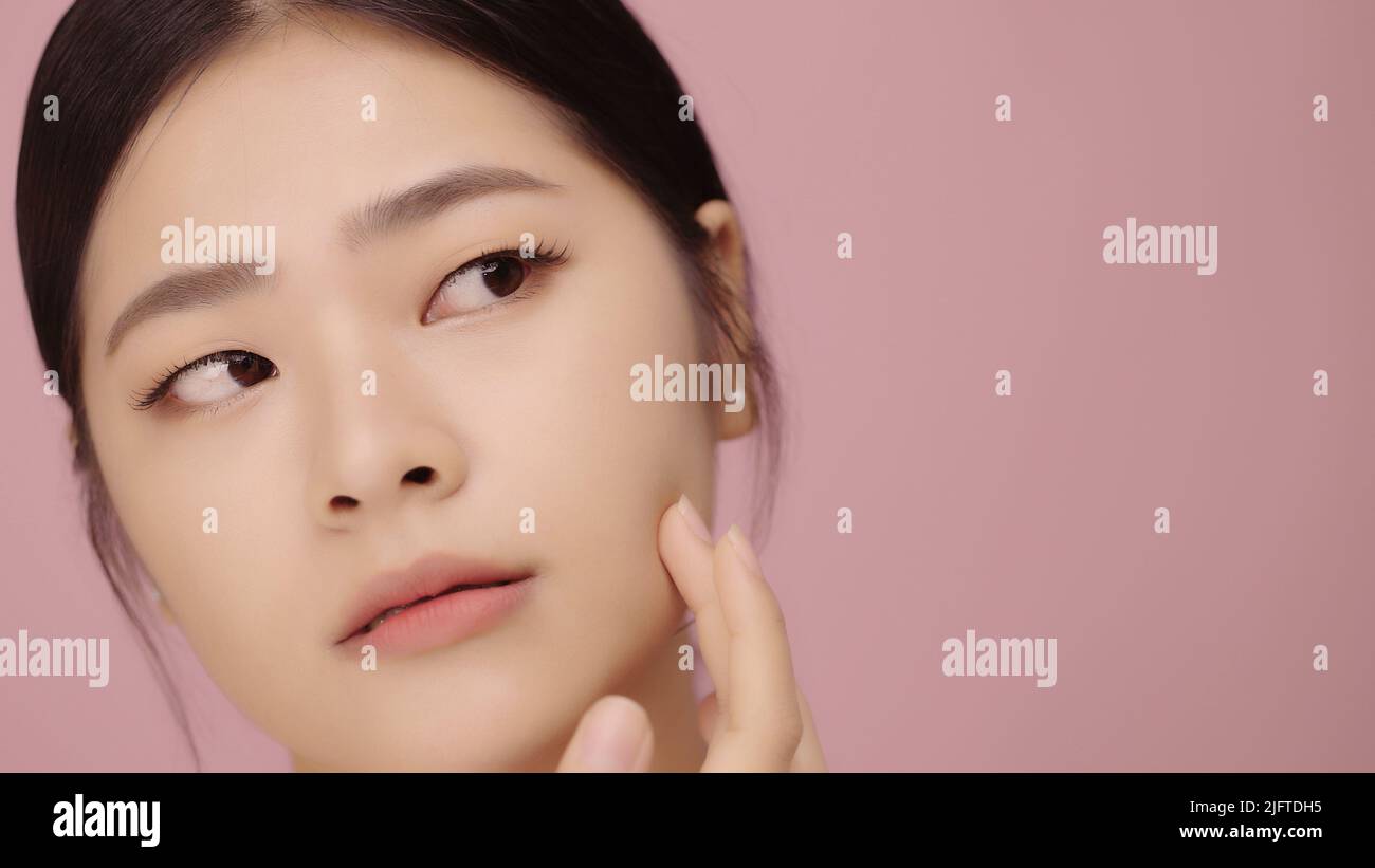 Close up face of young Asian woman worry about face skin problem on ...