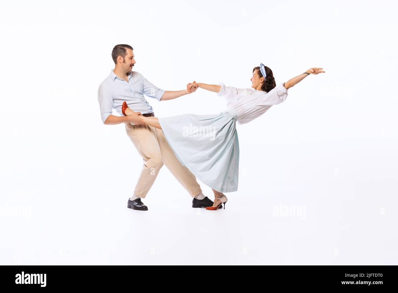 Portrait of young beautiful couple, man and woman, dancing rock and ...
