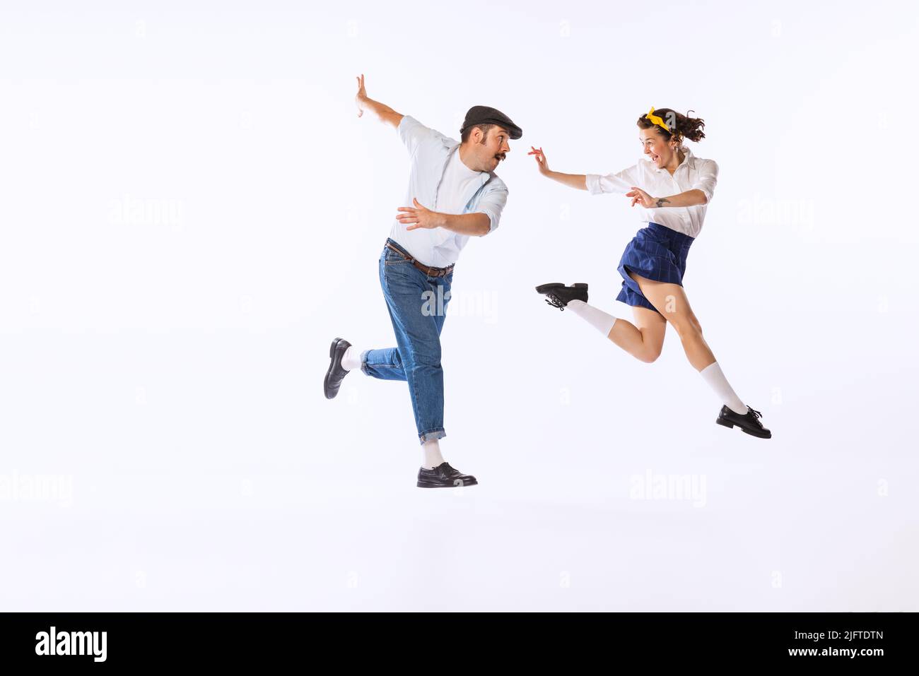 Portrait of excited, cheerful couple, man and woman, dancing, having ...