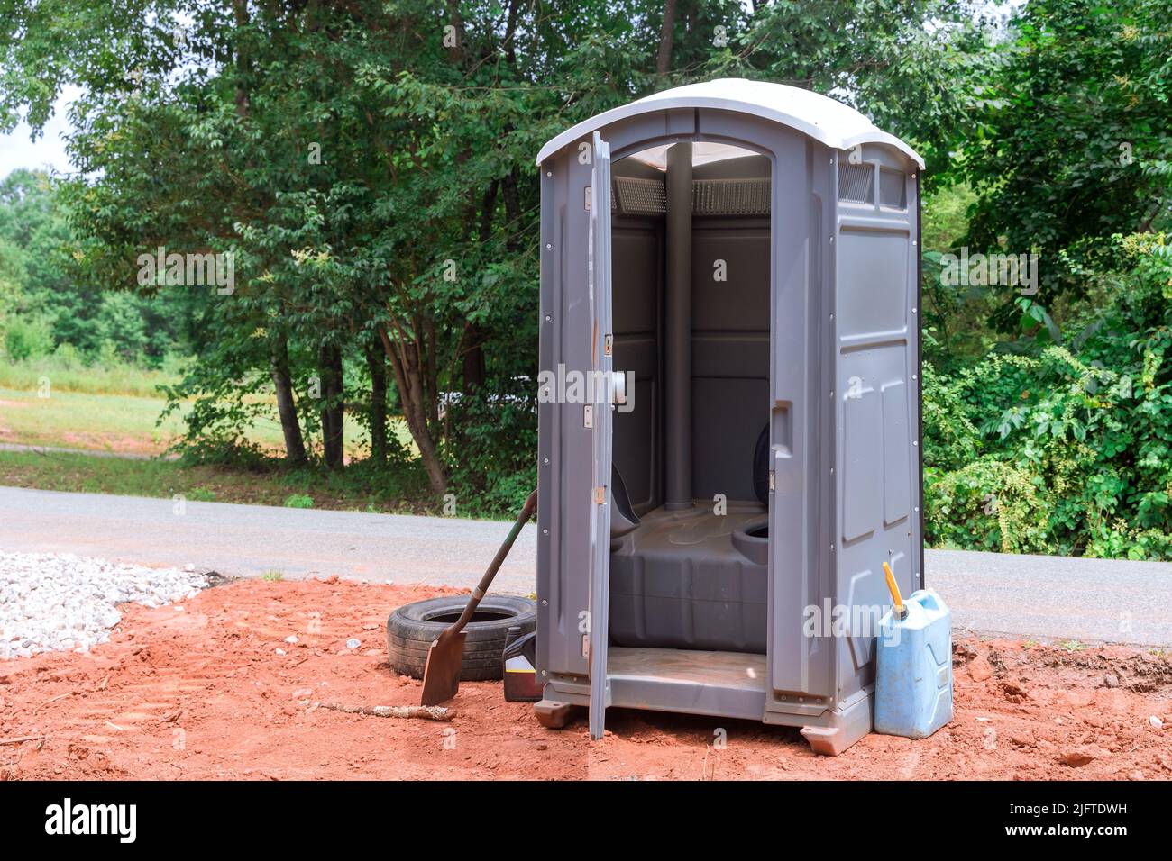 On a construction site, workers use a portable restroom Stock Photo - Alamy