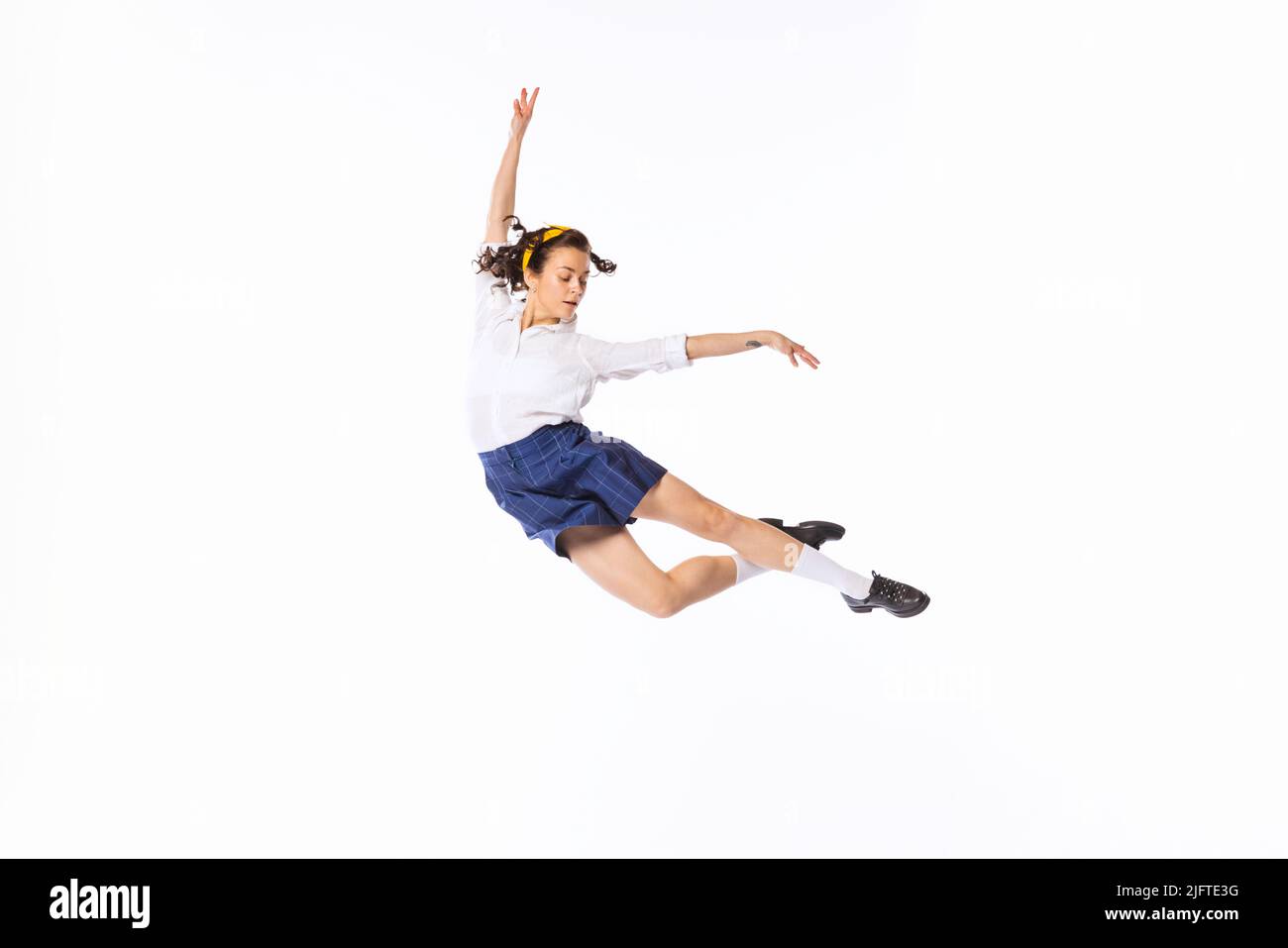 Portrait of beautiful young woman in retro outfit dancing, posing ...
