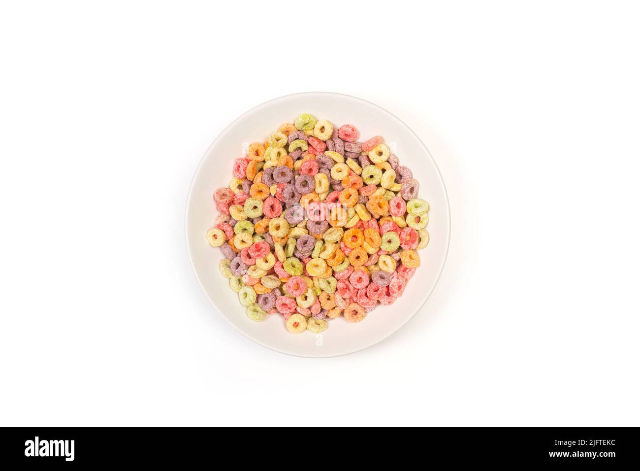 Fruit flavor colored cereals in a white plate on a white background in ...