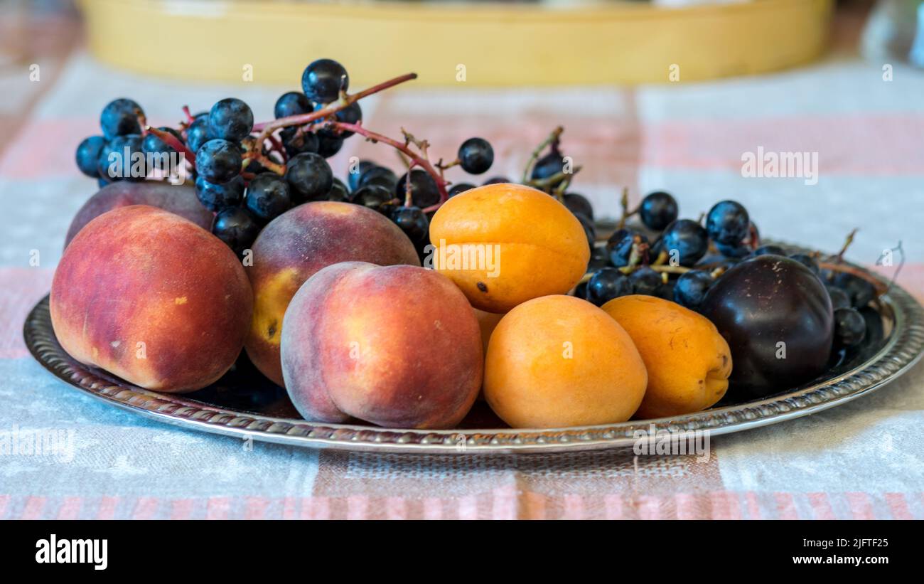 photo with fruit fragments on a metal tray, grapes, plums, peaches ...