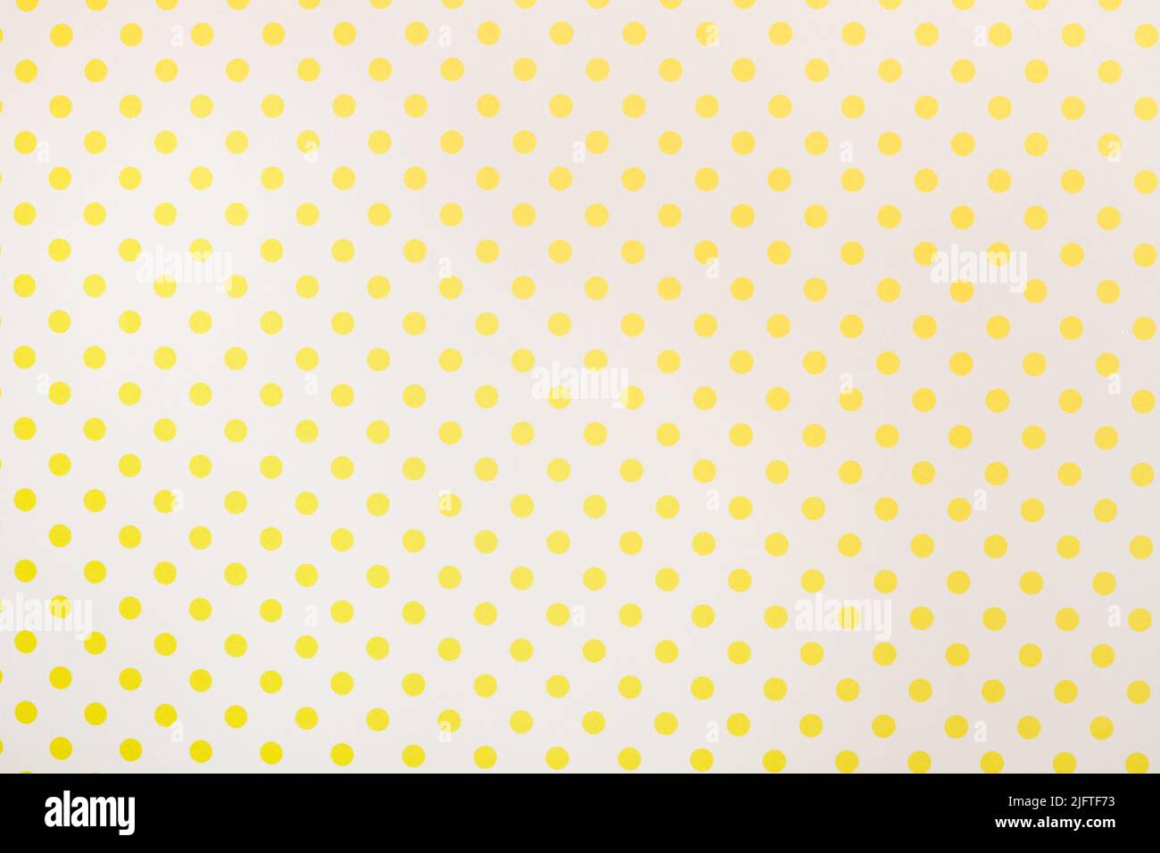 A gray paper background with yellow polka dots Stock Photo - Alamy