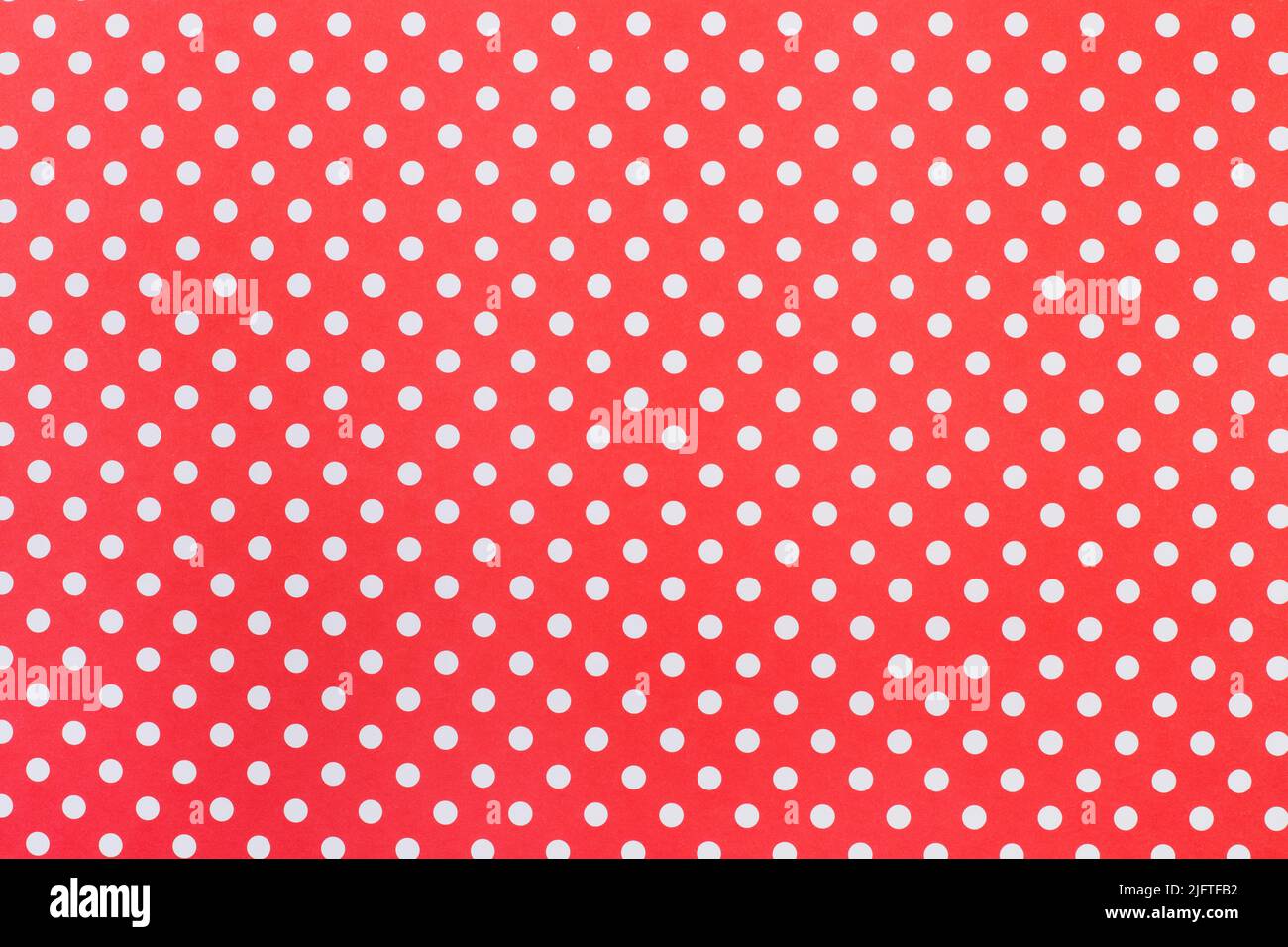 A red paper background with white polka dots Stock Photo - Alamy