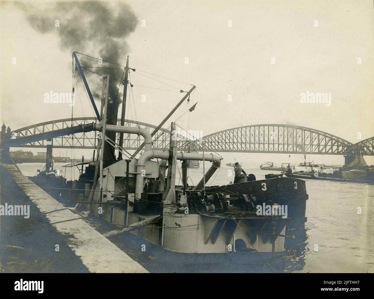 Steam sand dredger on the quay during the earthworks for the ...