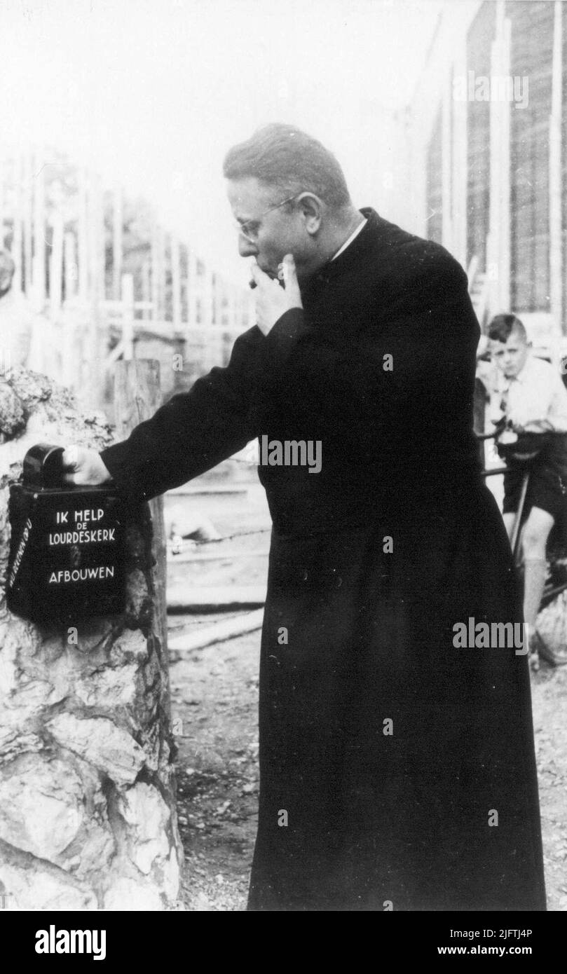 Father van de Lourdeskerk at a sacrificial block for the construction ...