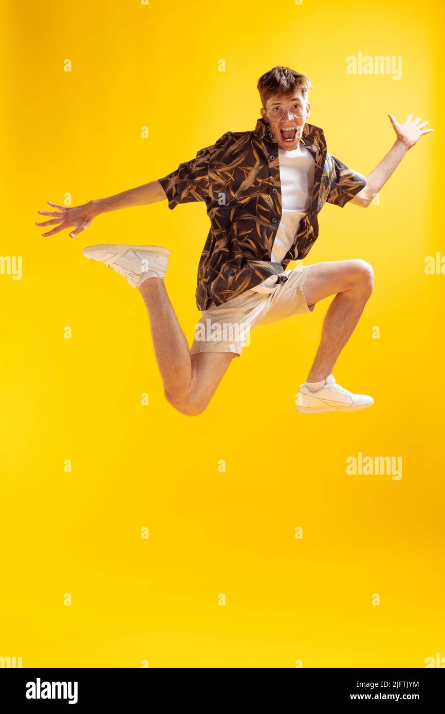 Full-length man's portrait isolated on bright yellow studio backgroud ...