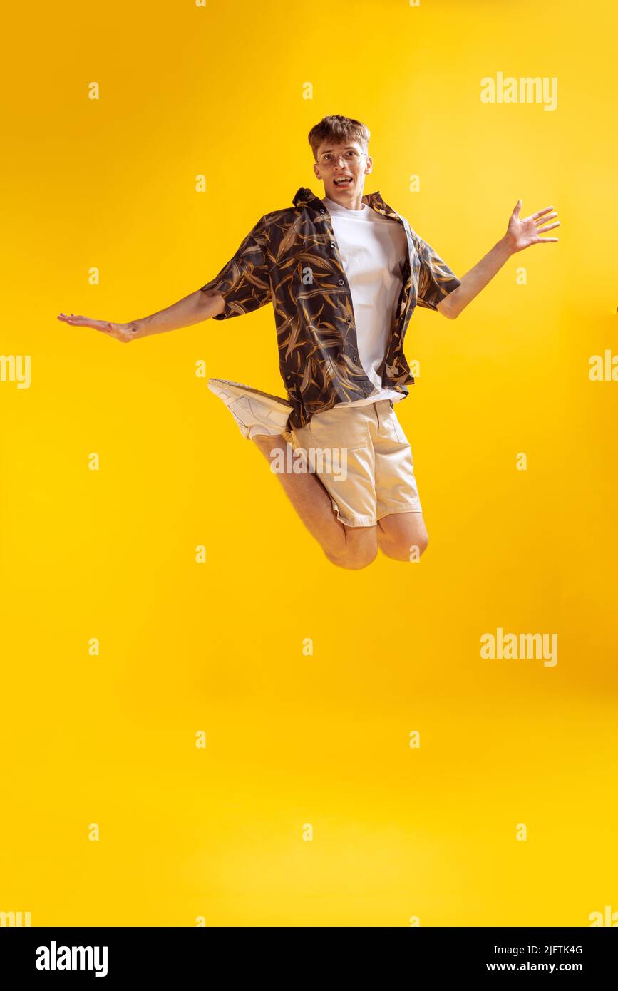 Full-length man's portrait isolated on bright yellow studio backgroud ...